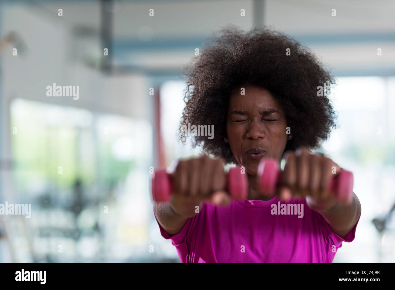 happy healthy african american woman working out in a crossfit gym on ...