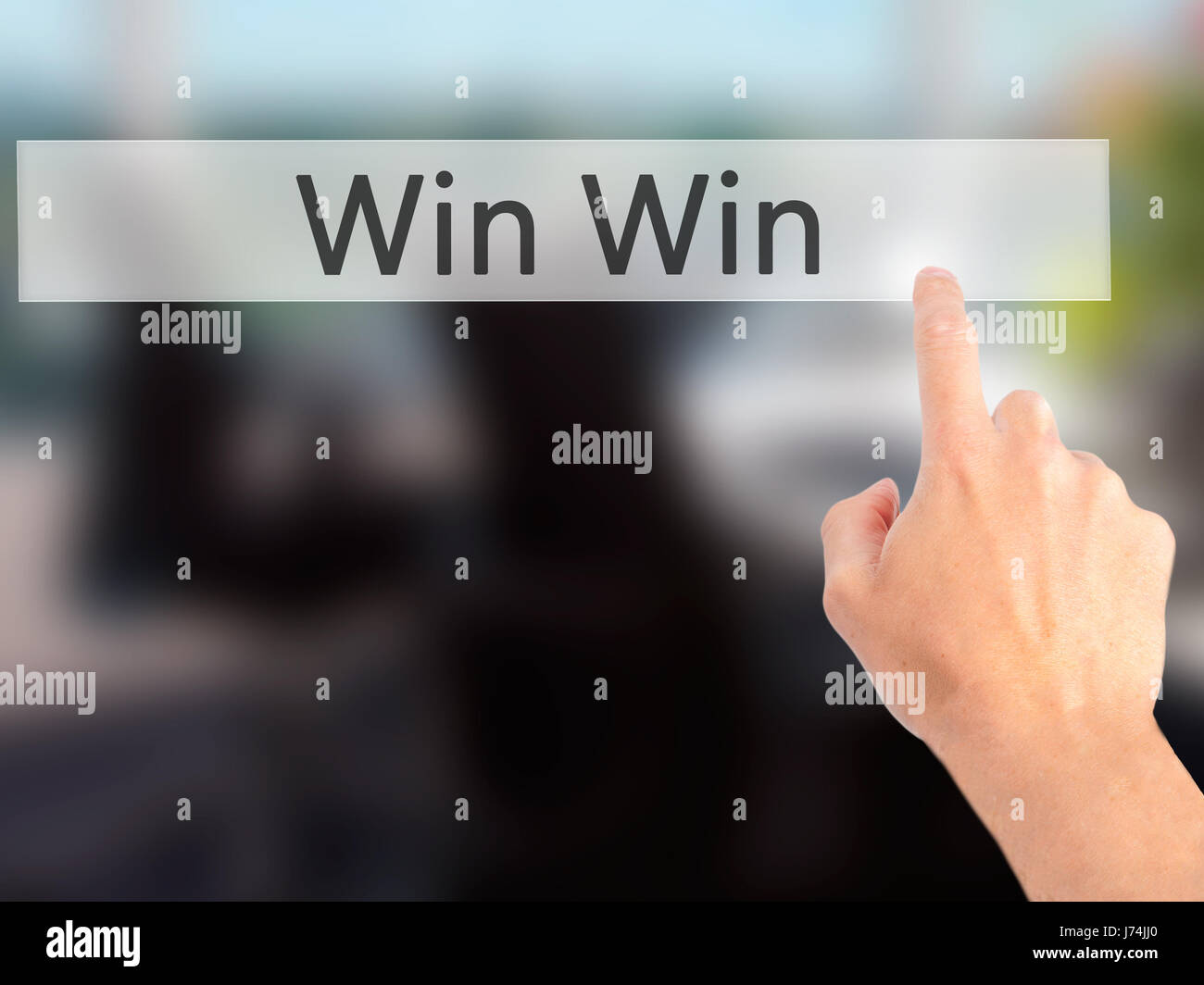Win Win - Hand pressing a button on blurred background concept ...