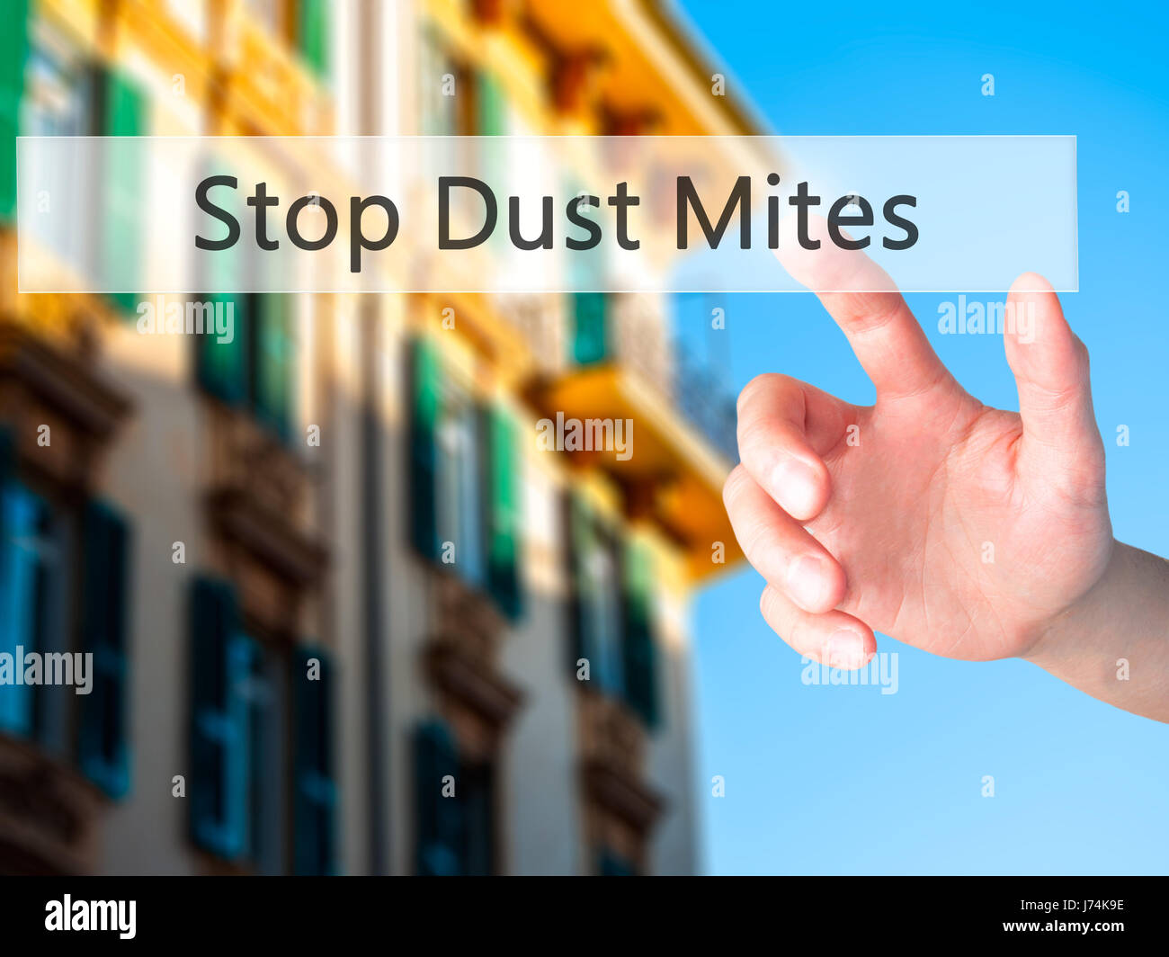Stop Dust Mites - Hand pressing a button on blurred background concept ...