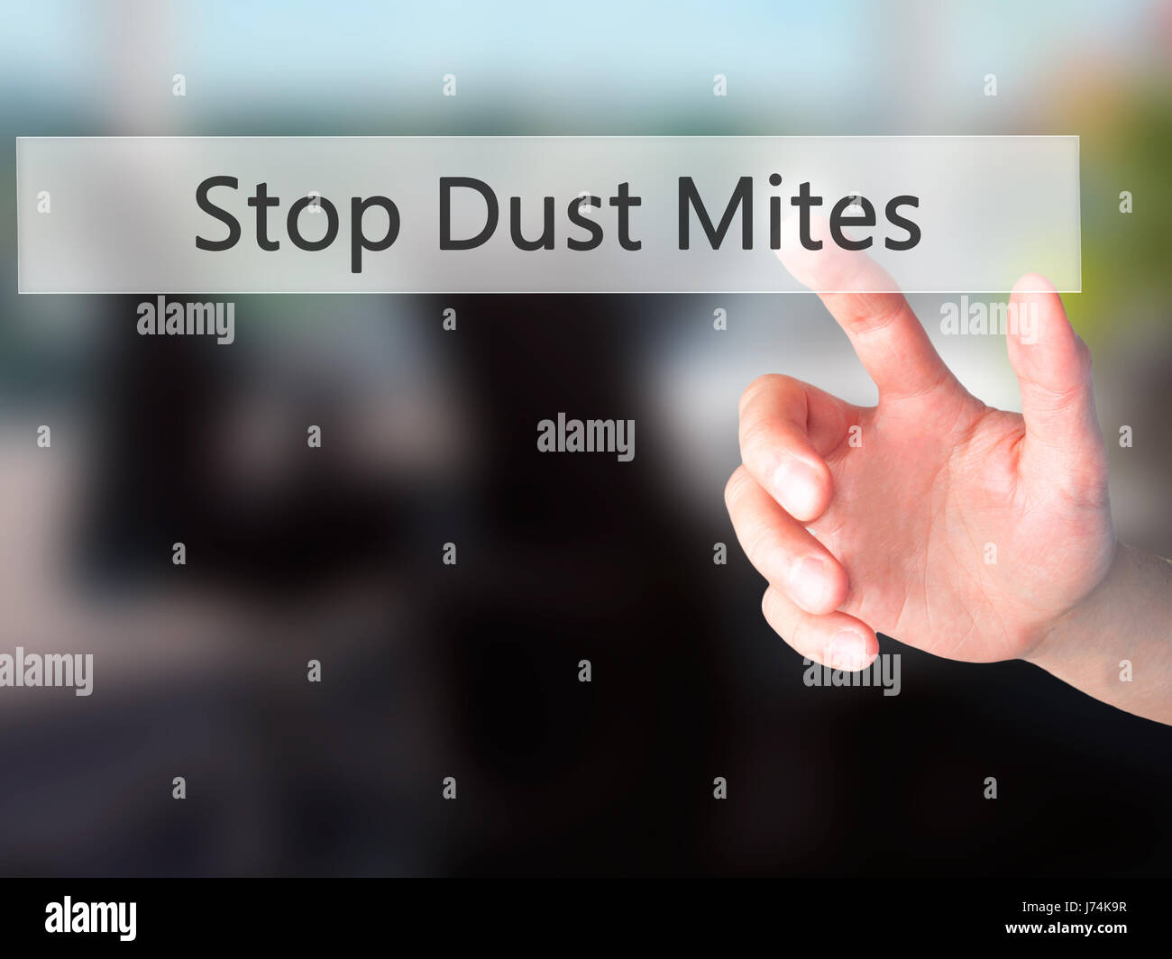 Stop Dust Mites - Hand pressing a button on blurred background concept ...