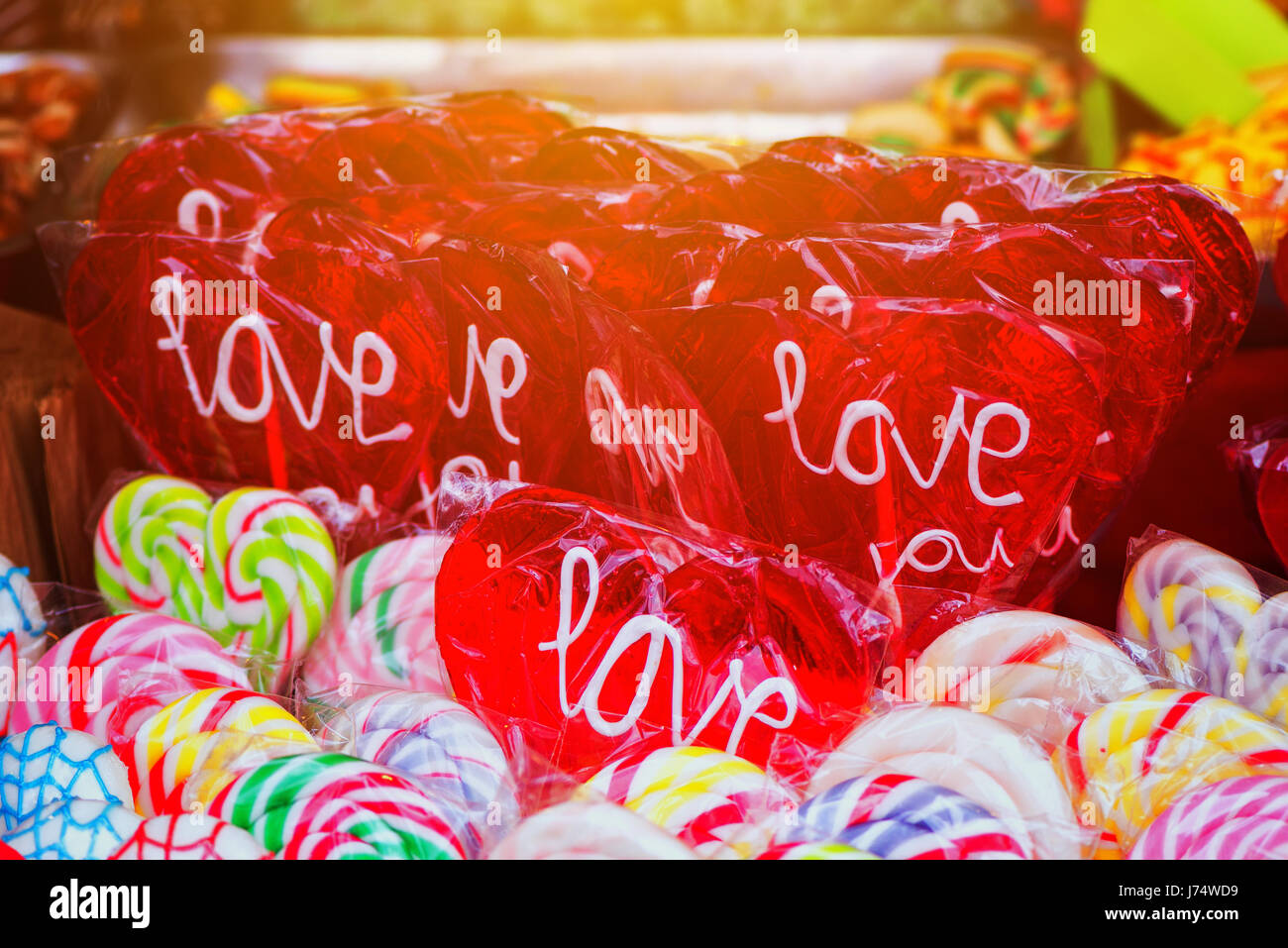 Heart shaped lollipop with word love on street market, type of hard ...