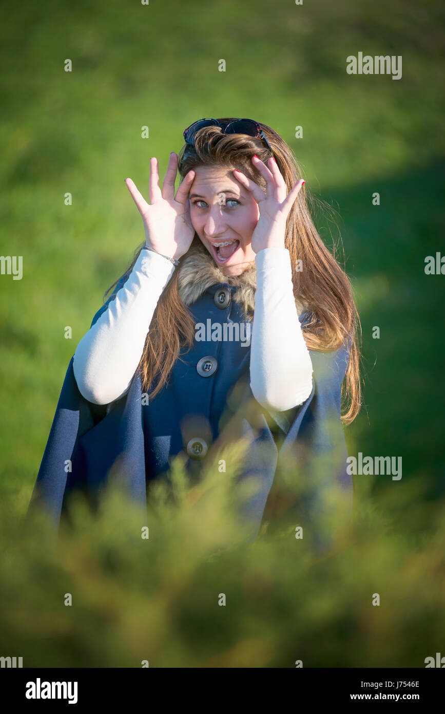 Beautiful and happy young girl posing outdoors Stock Photo - Alamy