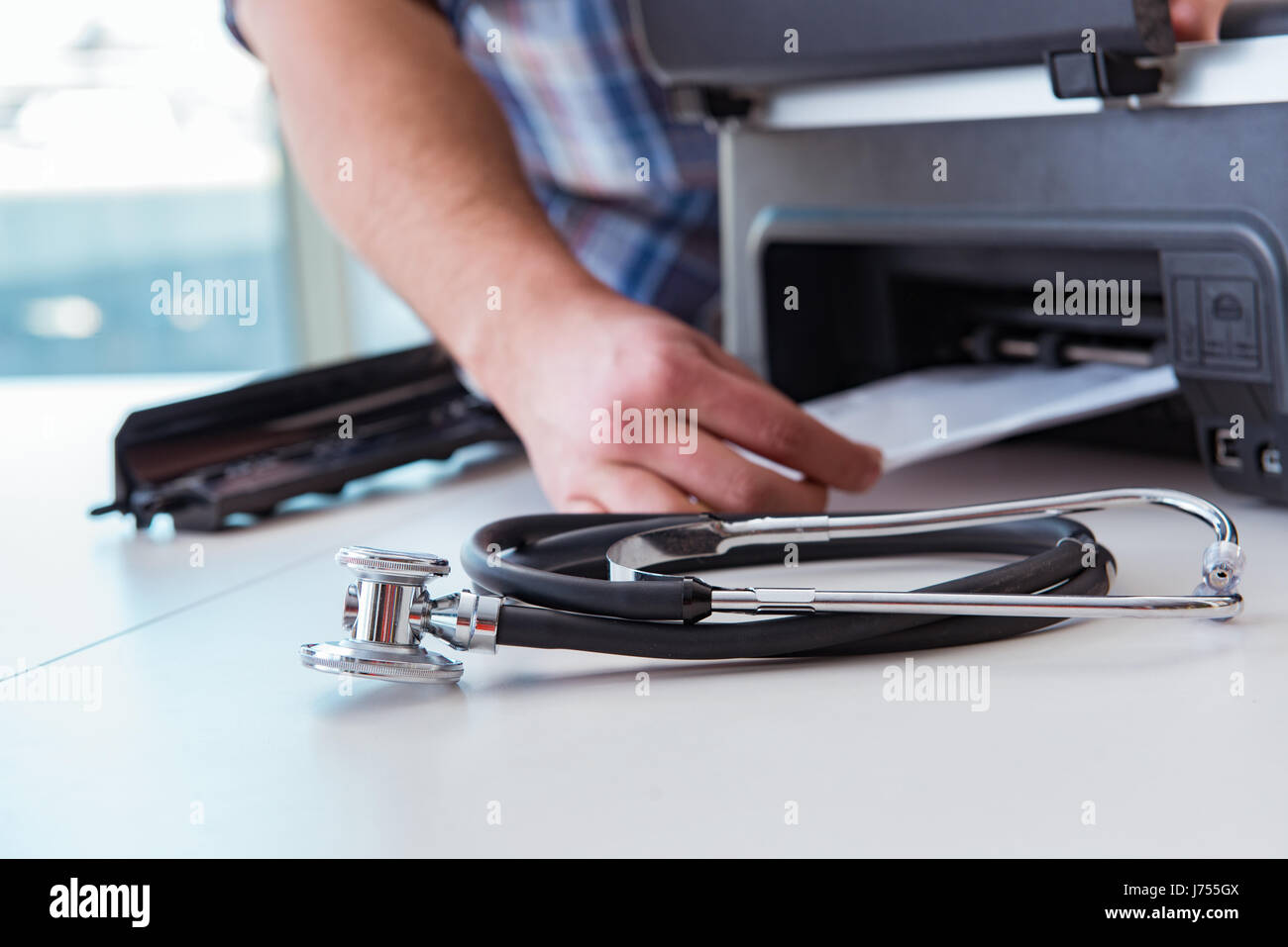 Repairman repairing broken color printer Stock Photo - Alamy