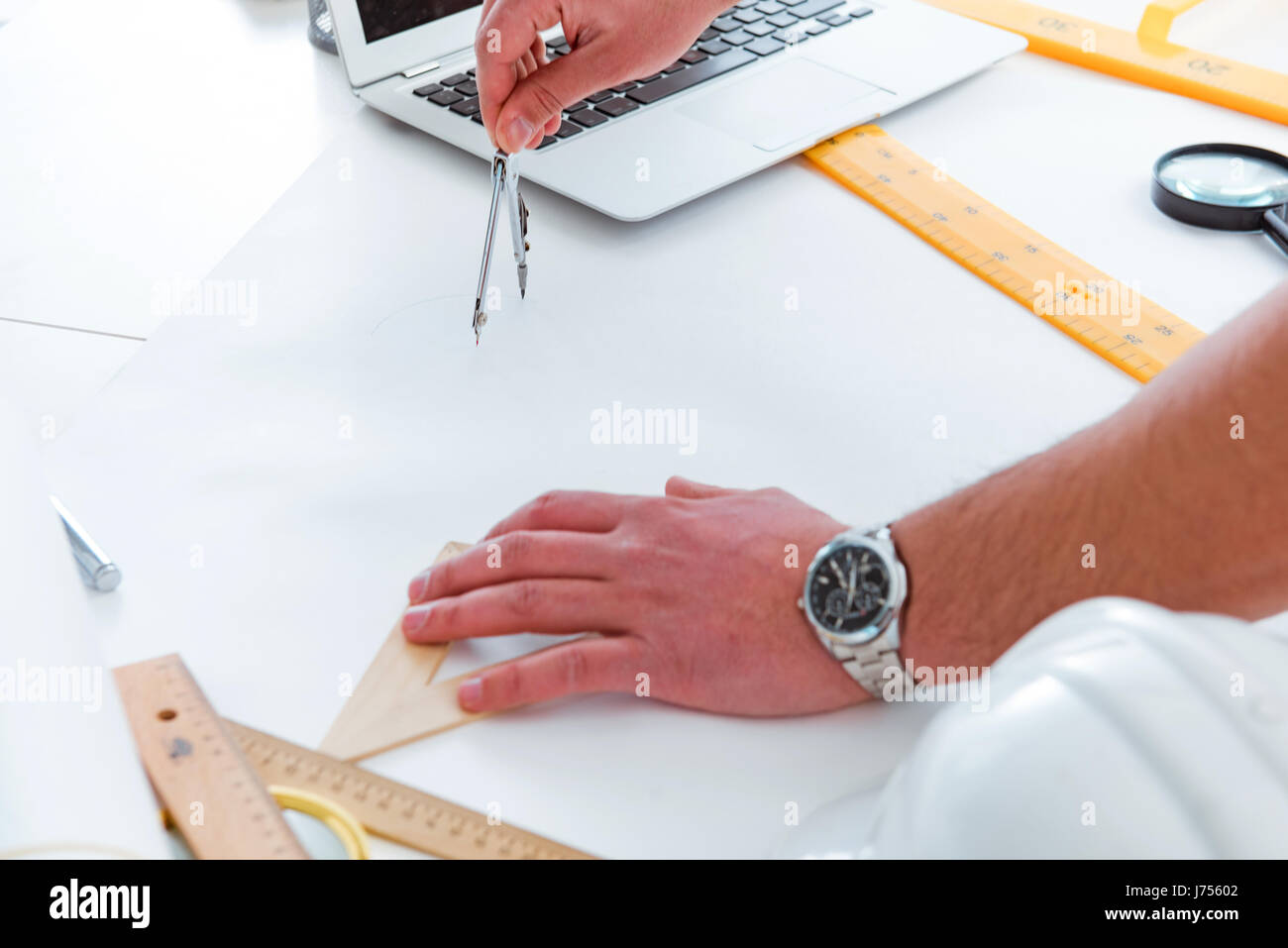 Male engineer working on drawings and blueprints Stock Photo - Alamy