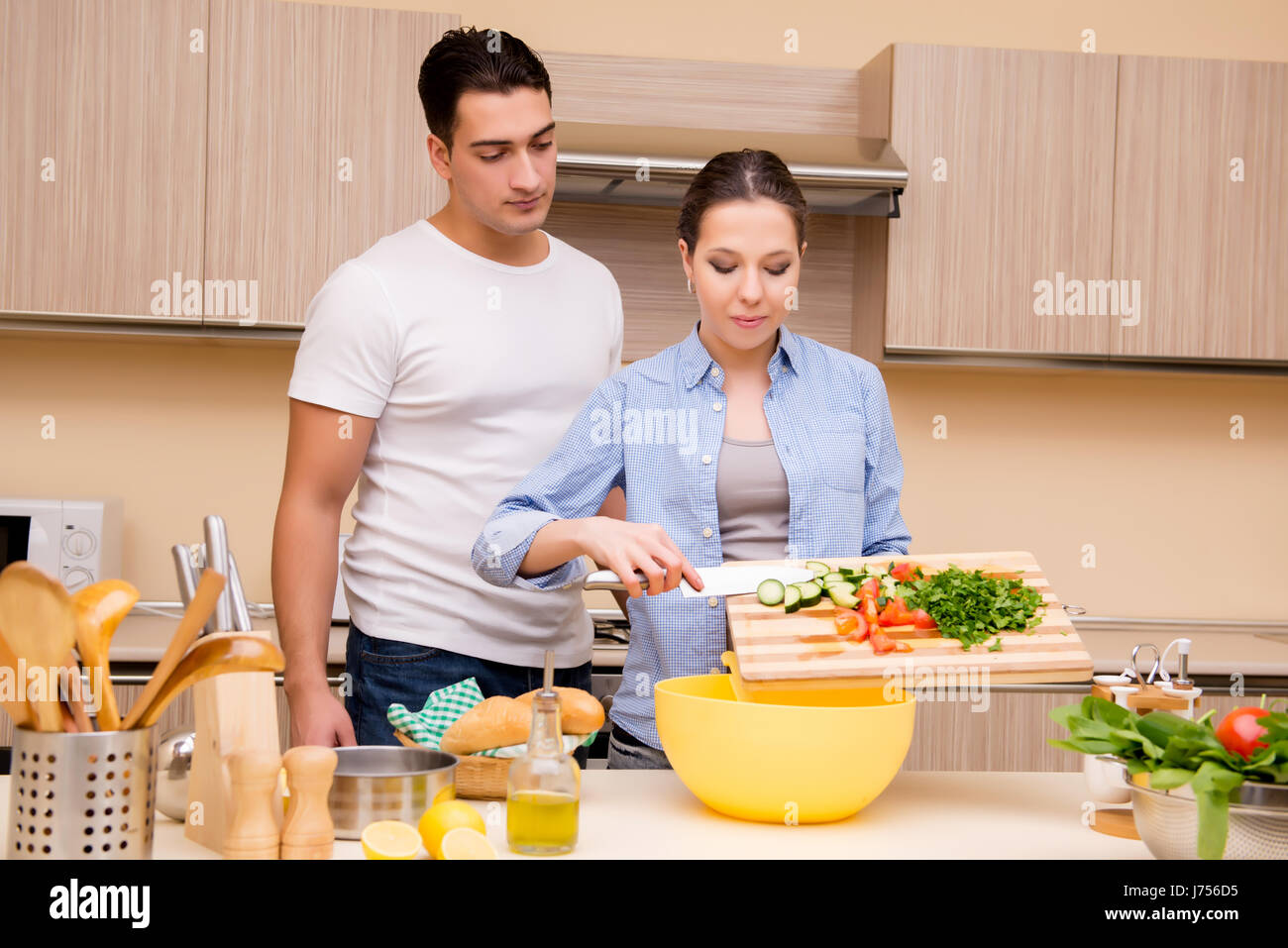 Young family in the kitchen Stock Photo - Alamy