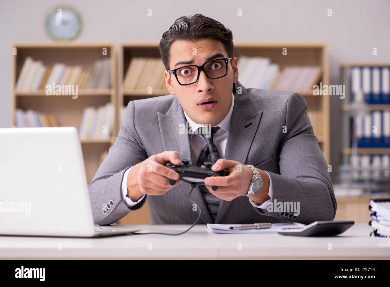 Businessman playing computer games at work office Stock Photo - Alamy