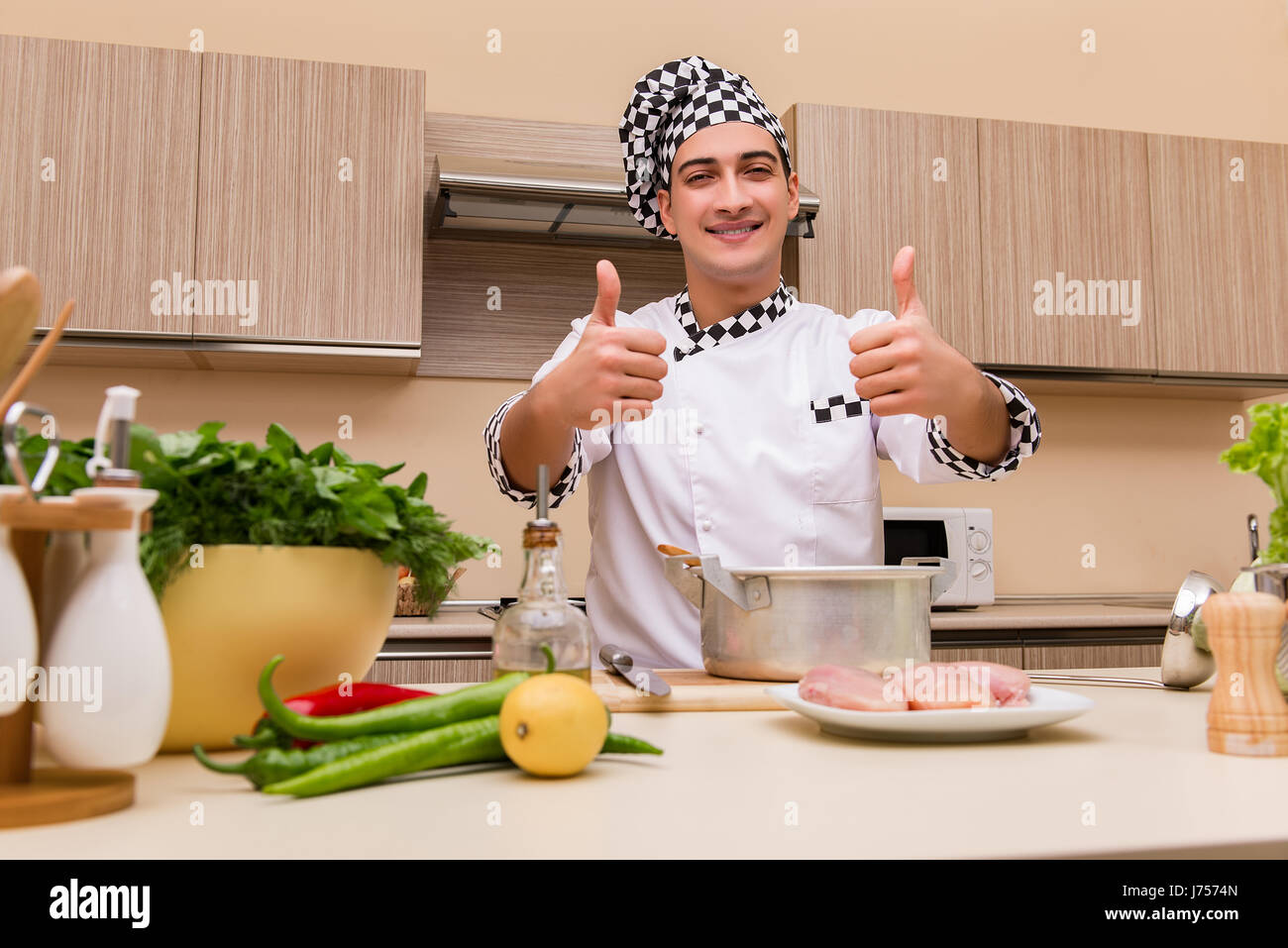 Young chef working in the kitchen Stock Photo - Alamy