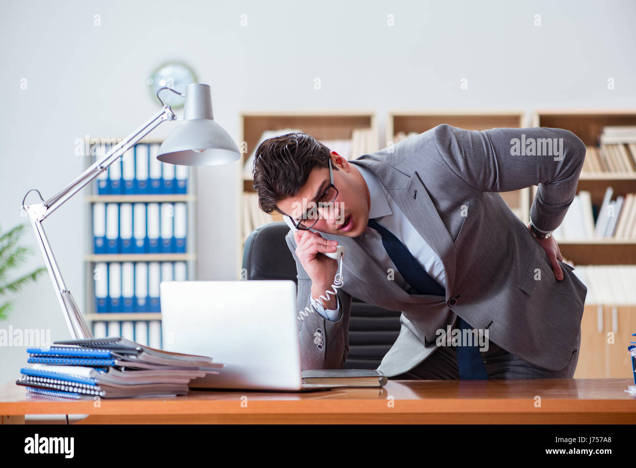 Businessman feeling lower back pain hi-res stock photography and images ...