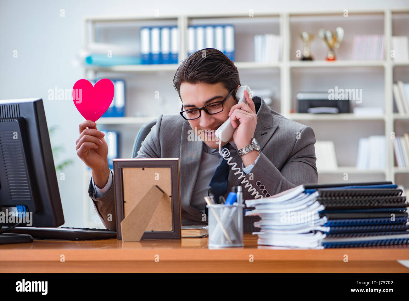 Businessman feeling love and loved in the office Stock Photo - Alamy