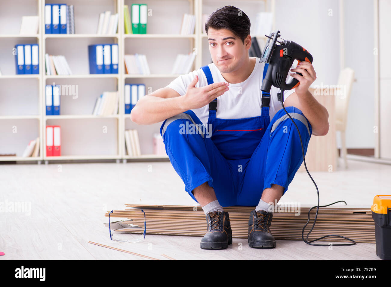 Young worker working on floor laminate tiles Stock Photo - Alamy