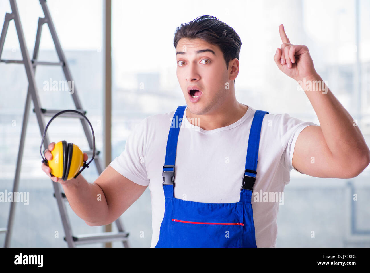 Worker with noise cancelling headphones Stock Photo - Alamy