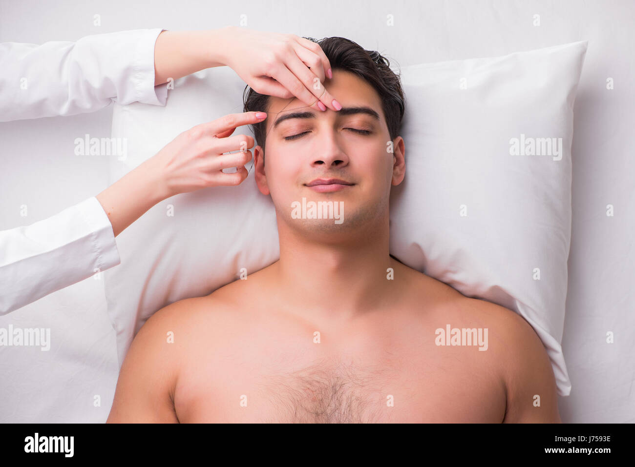 Handsome man in spa massage concept Stock Photo - Alamy