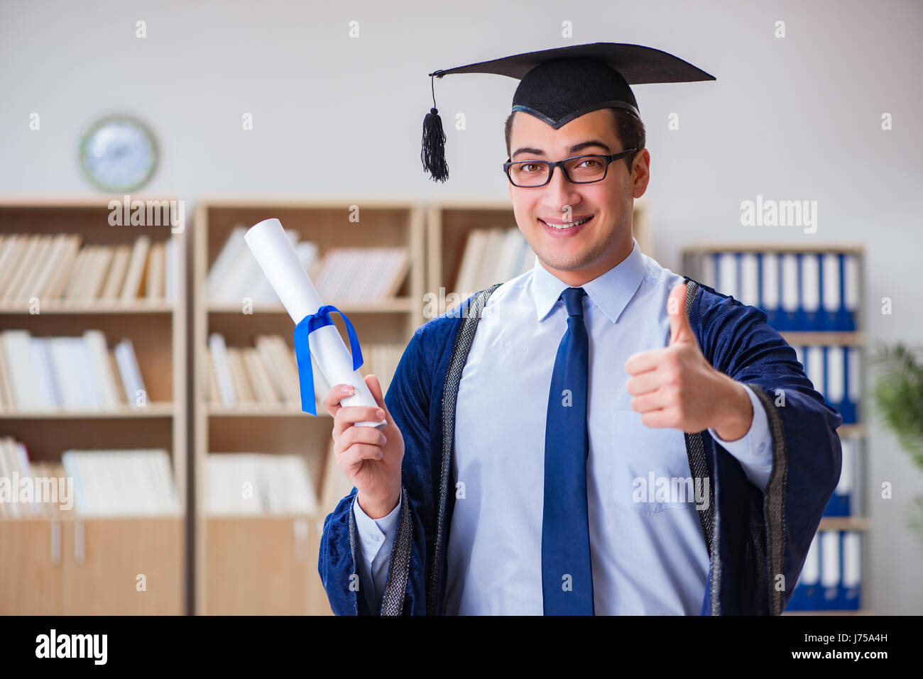 Young man graduating from university Stock Photo - Alamy