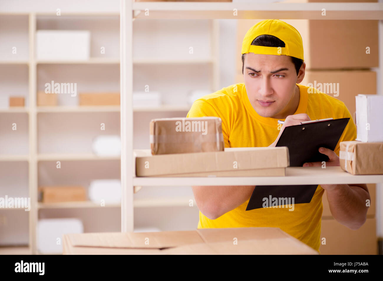 Man working in postal parcel delivery service office Stock Photo - Alamy