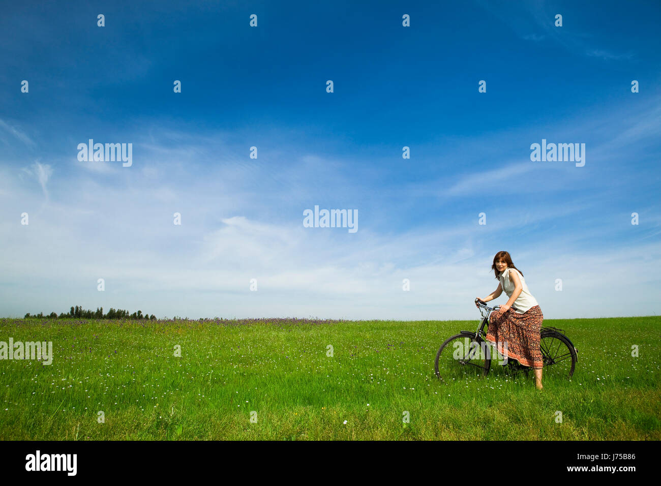 woman field spring bouncing bounces hop skipping frisks jumping jump ...