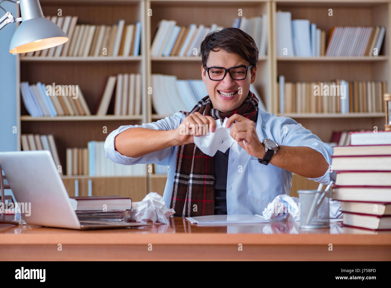 Young book writer writing in library Stock Photo - Alamy