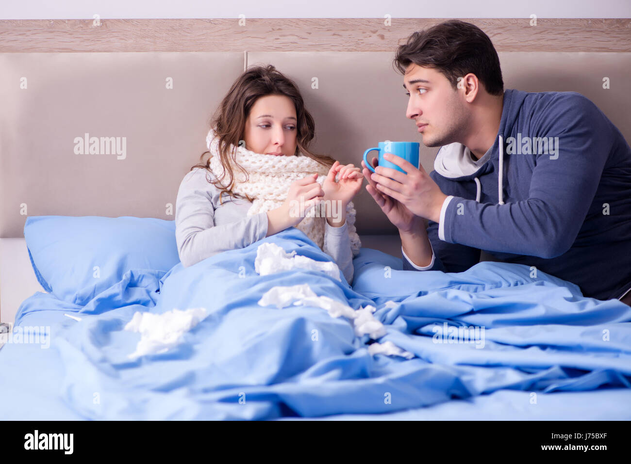 Wife caring for sick husband at home in bed Stock Photo - Alamy