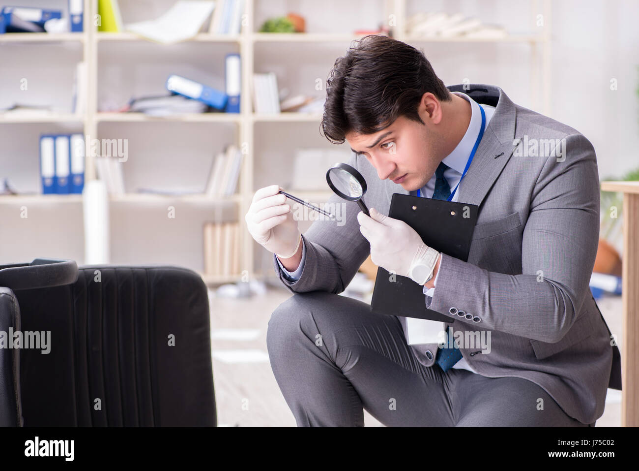 Young man during crime investigation in office Stock Photo - Alamy