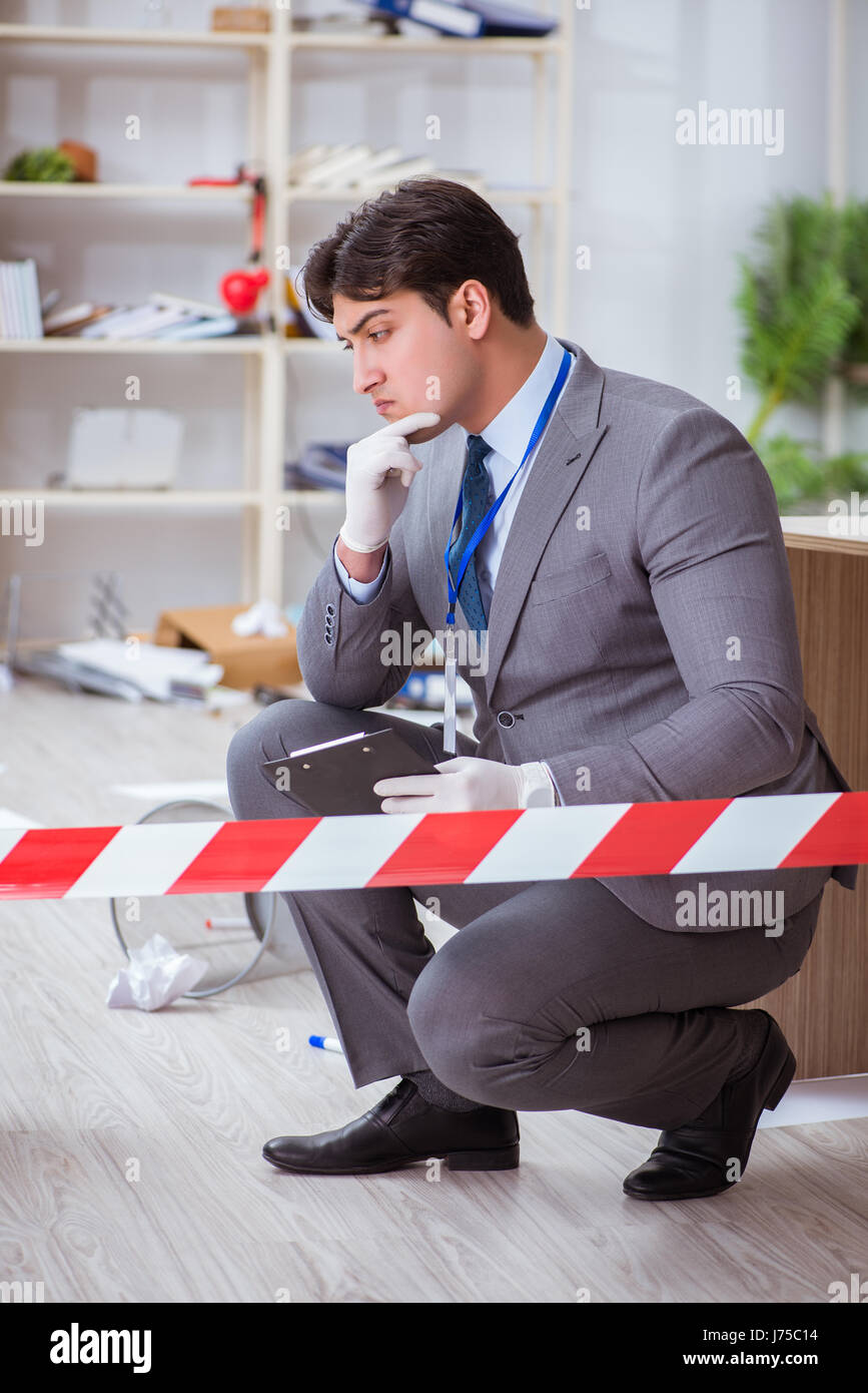 Young man during crime investigation in office Stock Photo - Alamy