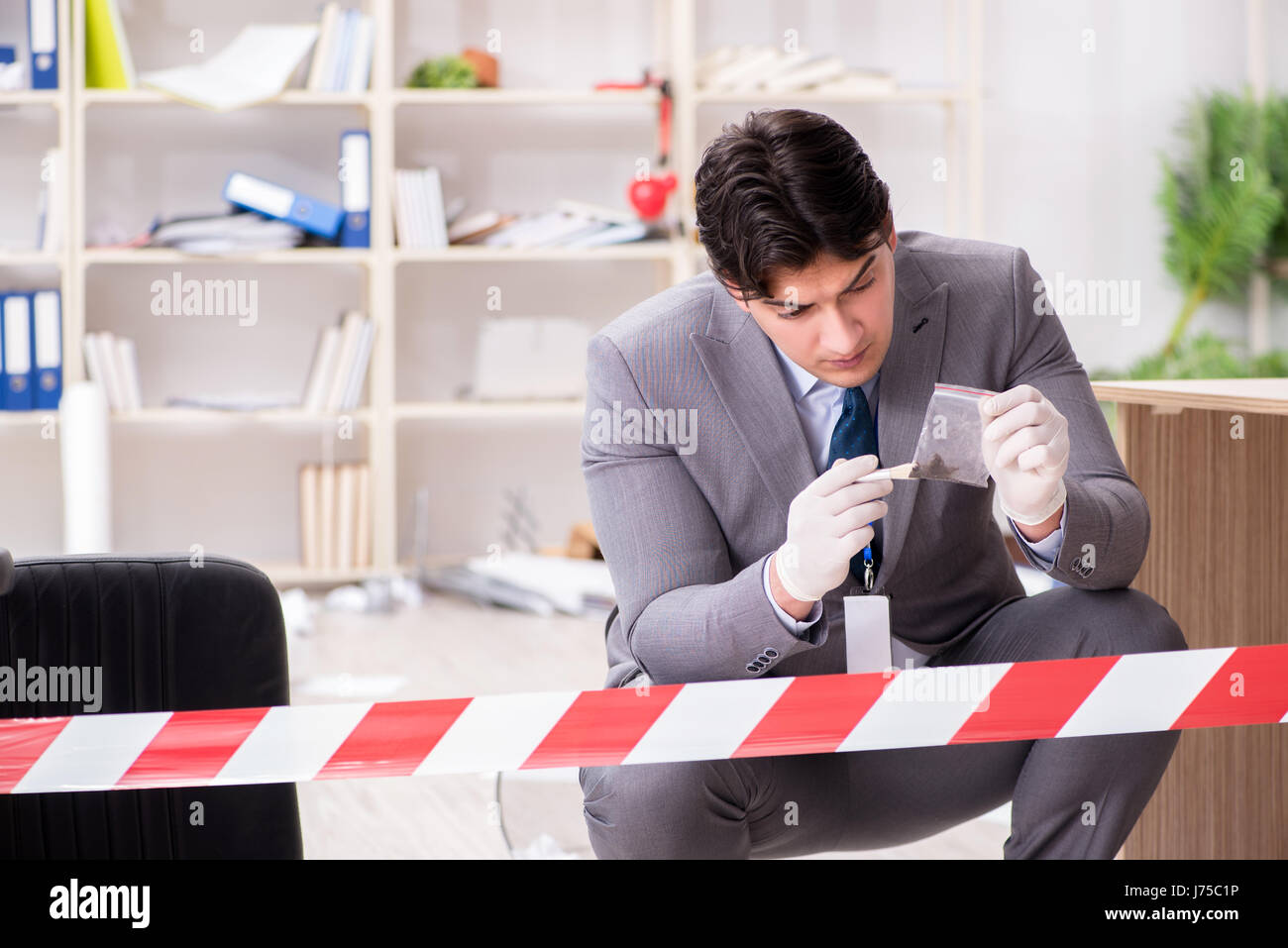 Young man during crime investigation in office Stock Photo - Alamy