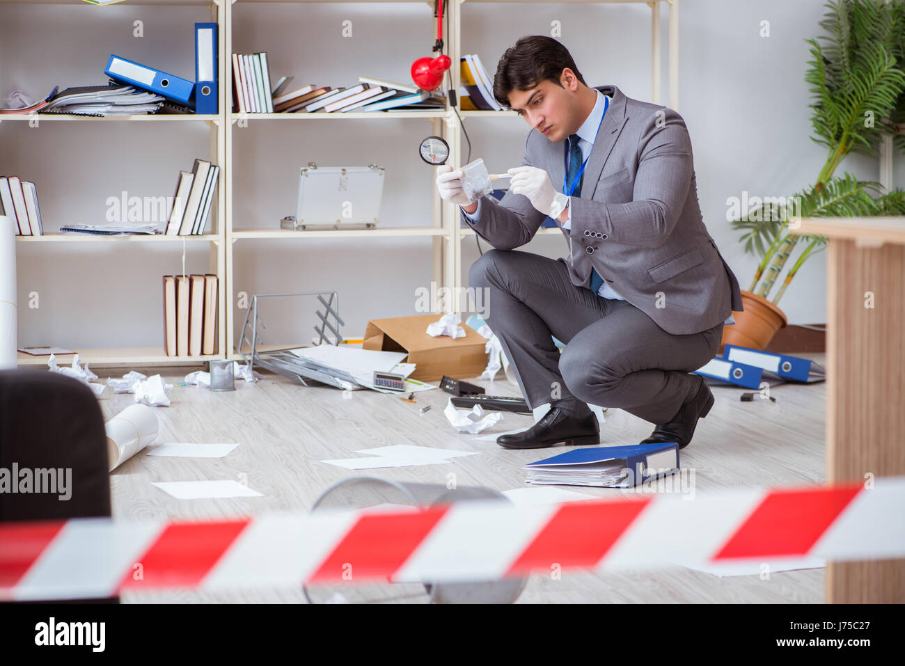 Young man during crime investigation in office Stock Photo - Alamy