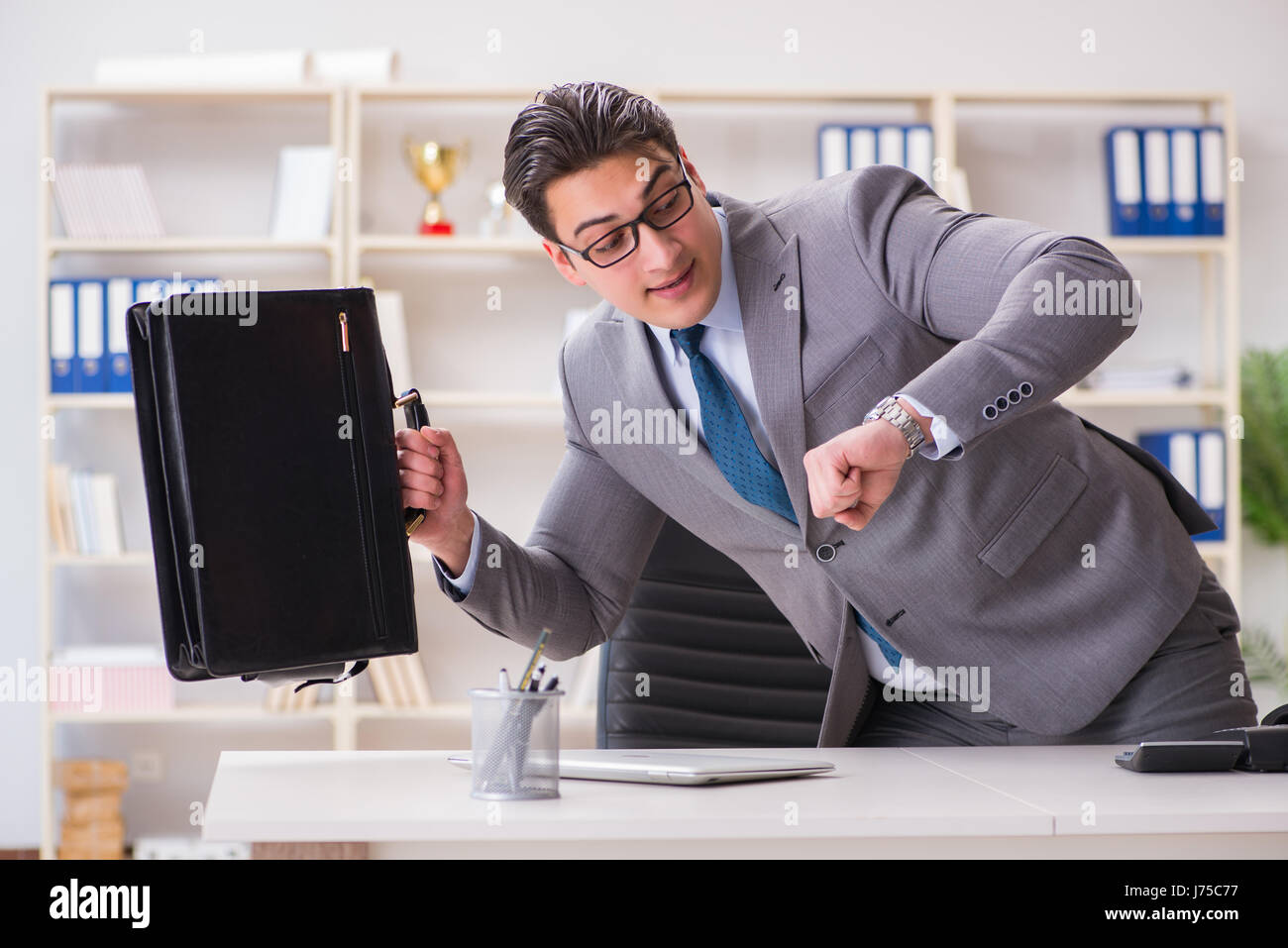 Businessman rushing in the office Stock Photo - Alamy