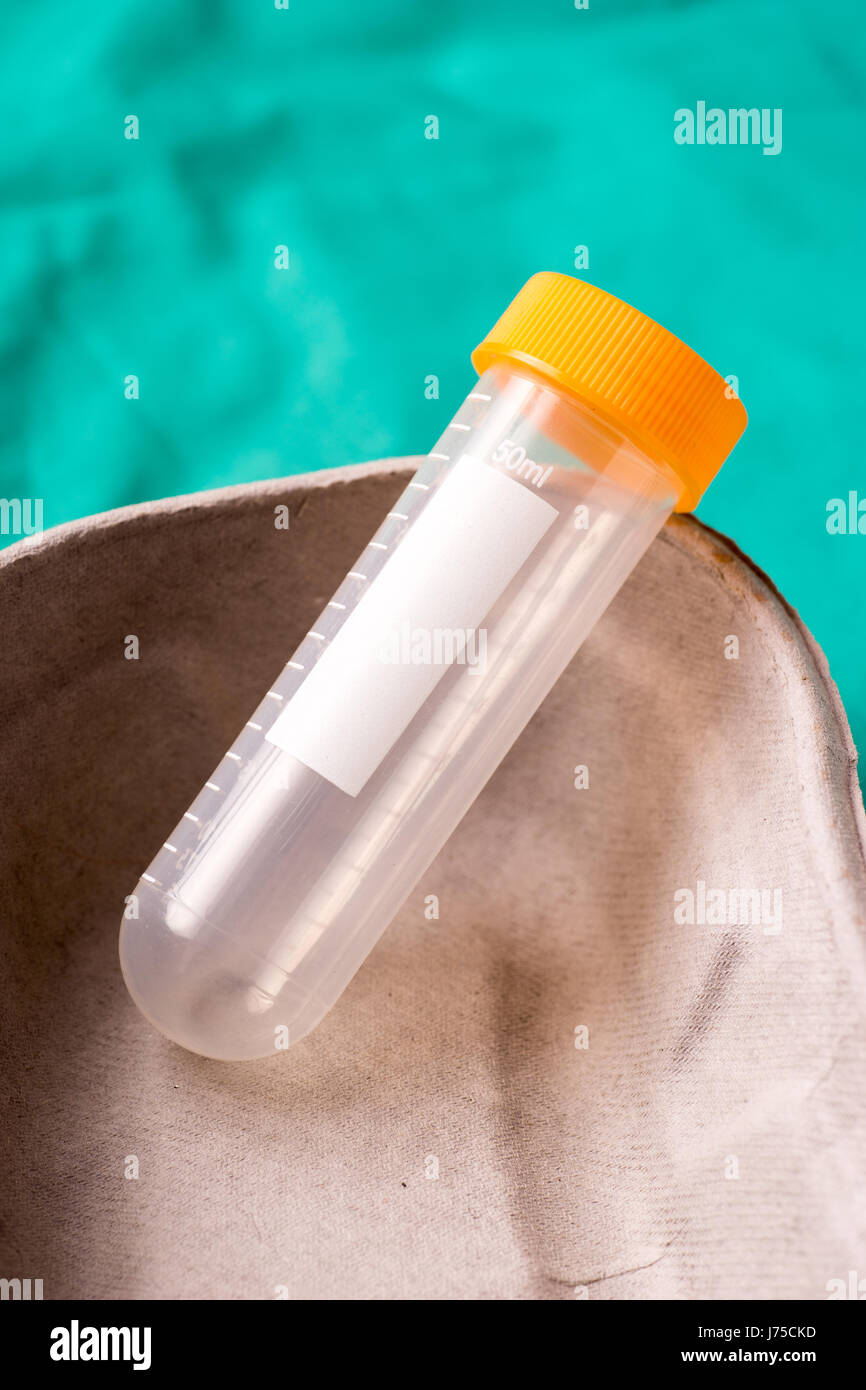 Medical test tube lying in a one use capsule on the hospital's green ...