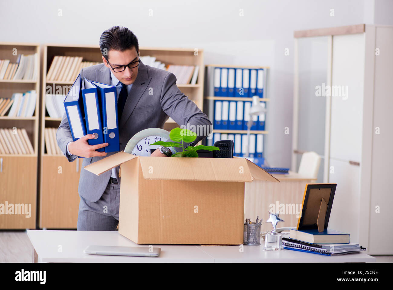 Man moving office with box and his belongings Stock Photo - Alamy