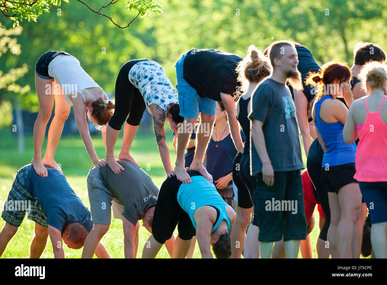 Group of Young Acrobatic People Exercising in Forming a Pyramid Stock ...