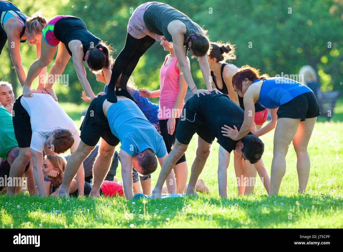 Group of Young Acrobatic People Exercising in Forming a Pyramid Stock ...