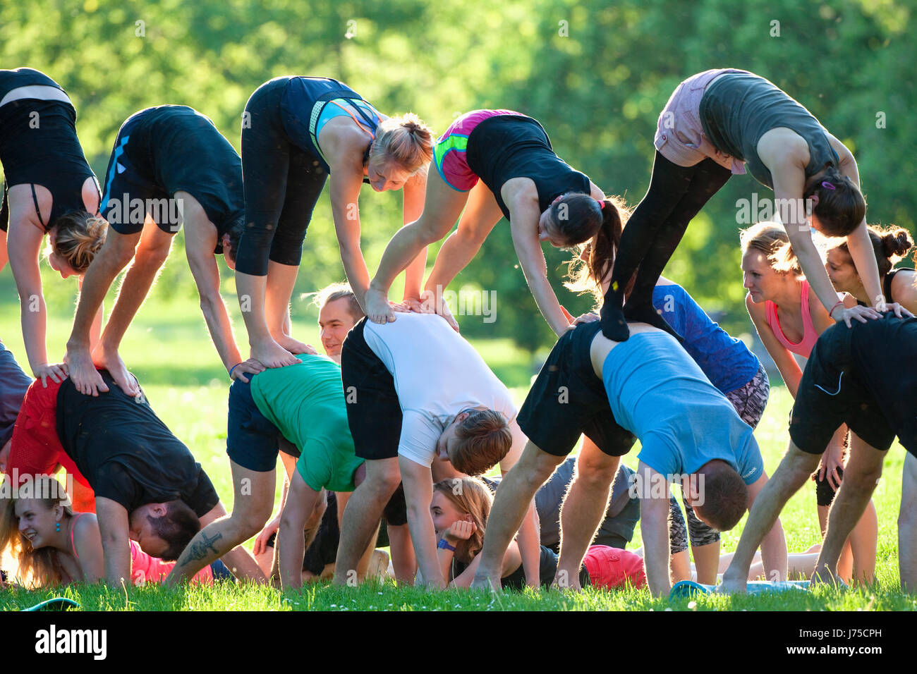 Group of Young Acrobatic People Exercising in Forming a Pyramid Stock ...