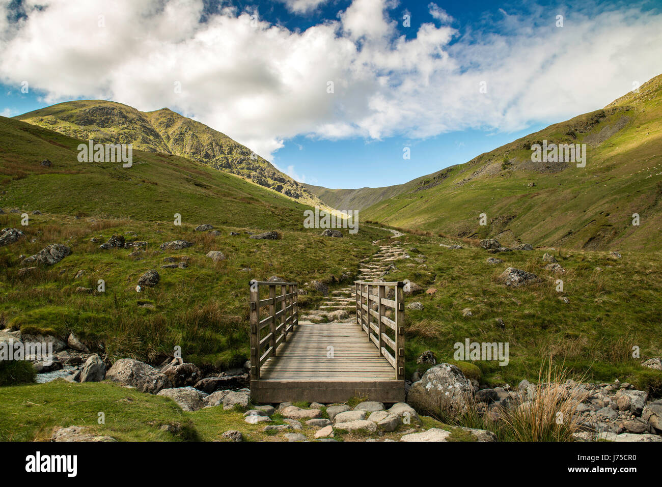 Cumbrian Landscape depicting wooden bridge crossing Red Tarn Beck and ...
