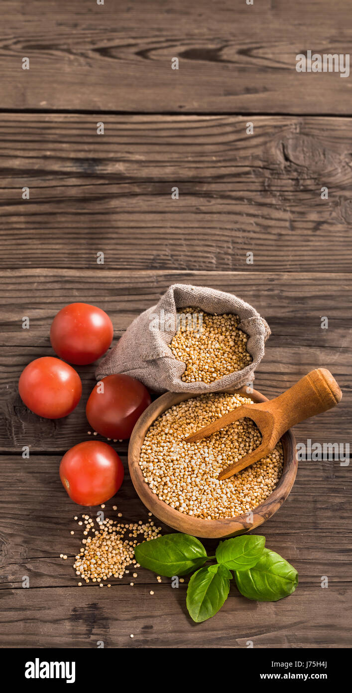 Uncooked quinoa with tomatoes vertical Stock Photo - Alamy