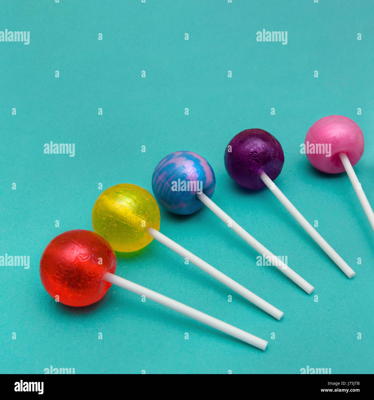 Lollipop Minimal concept Five colorful round lollipops are lying on a ...