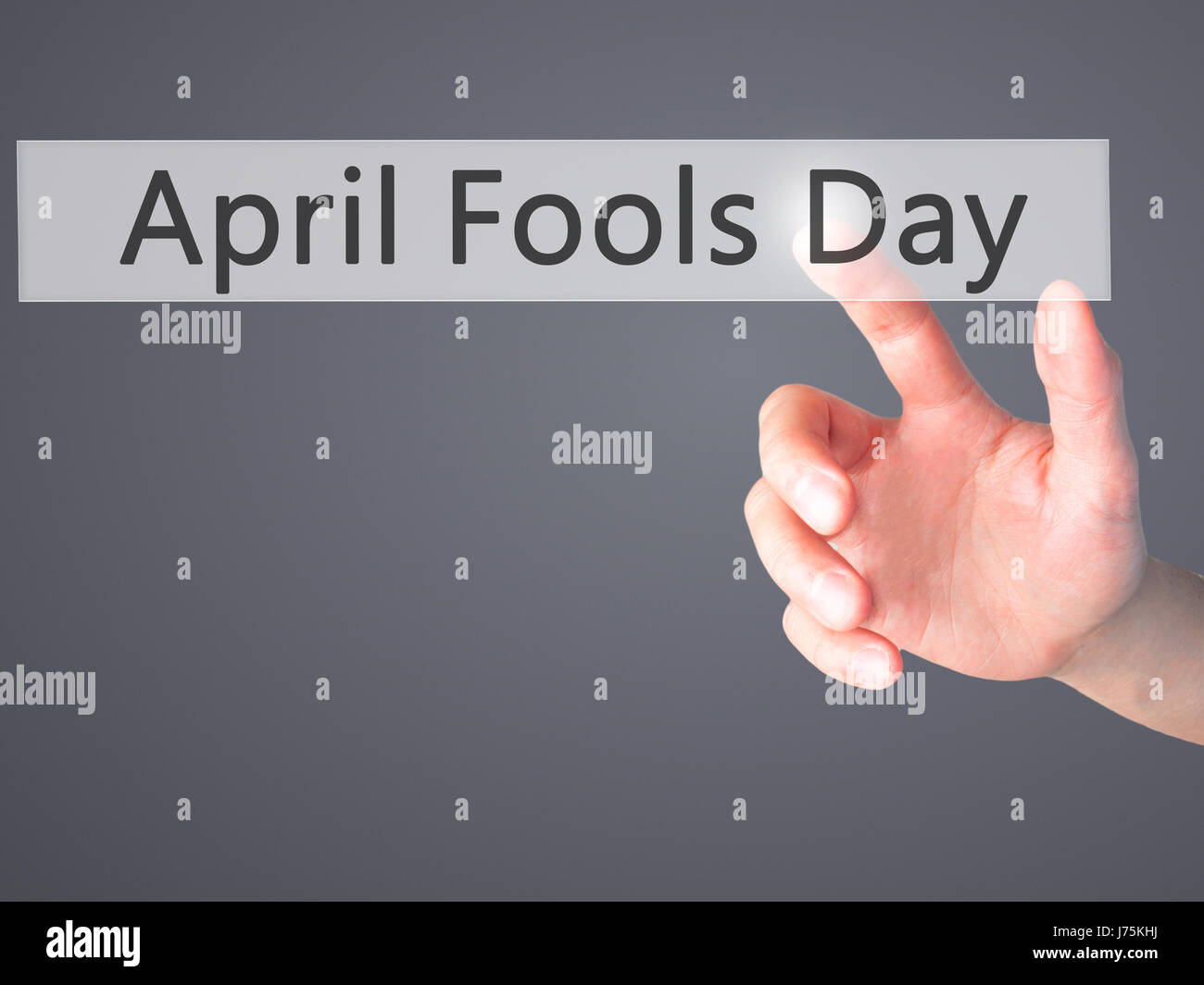 April Fools Day - Hand pressing a button on blurred background concept ...