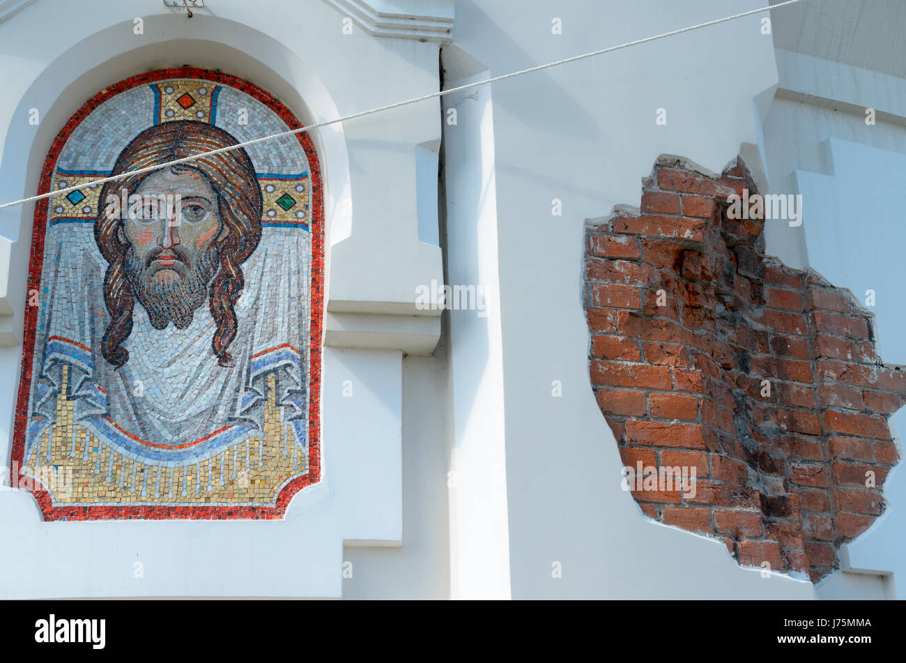 The image of Christ on the wall next to the bare brick Stock Photo - Alamy