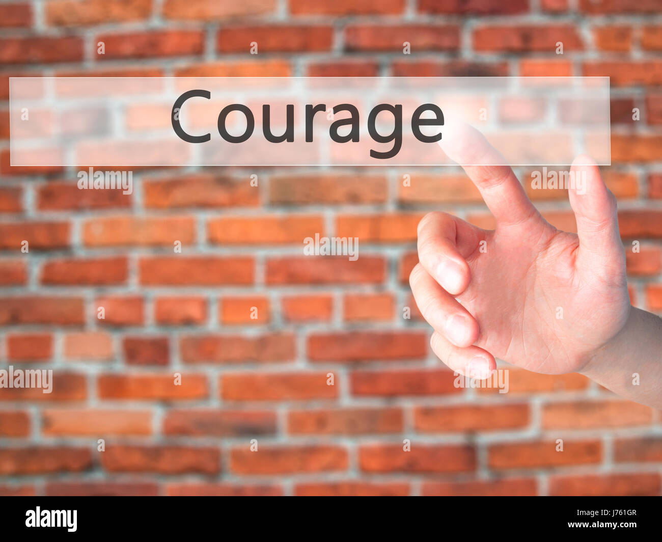 Courage - Hand pressing a button on blurred background concept ...