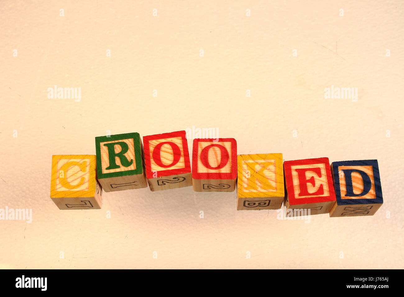 The term crooked visually displayed using colorful wooden toy blocks ...