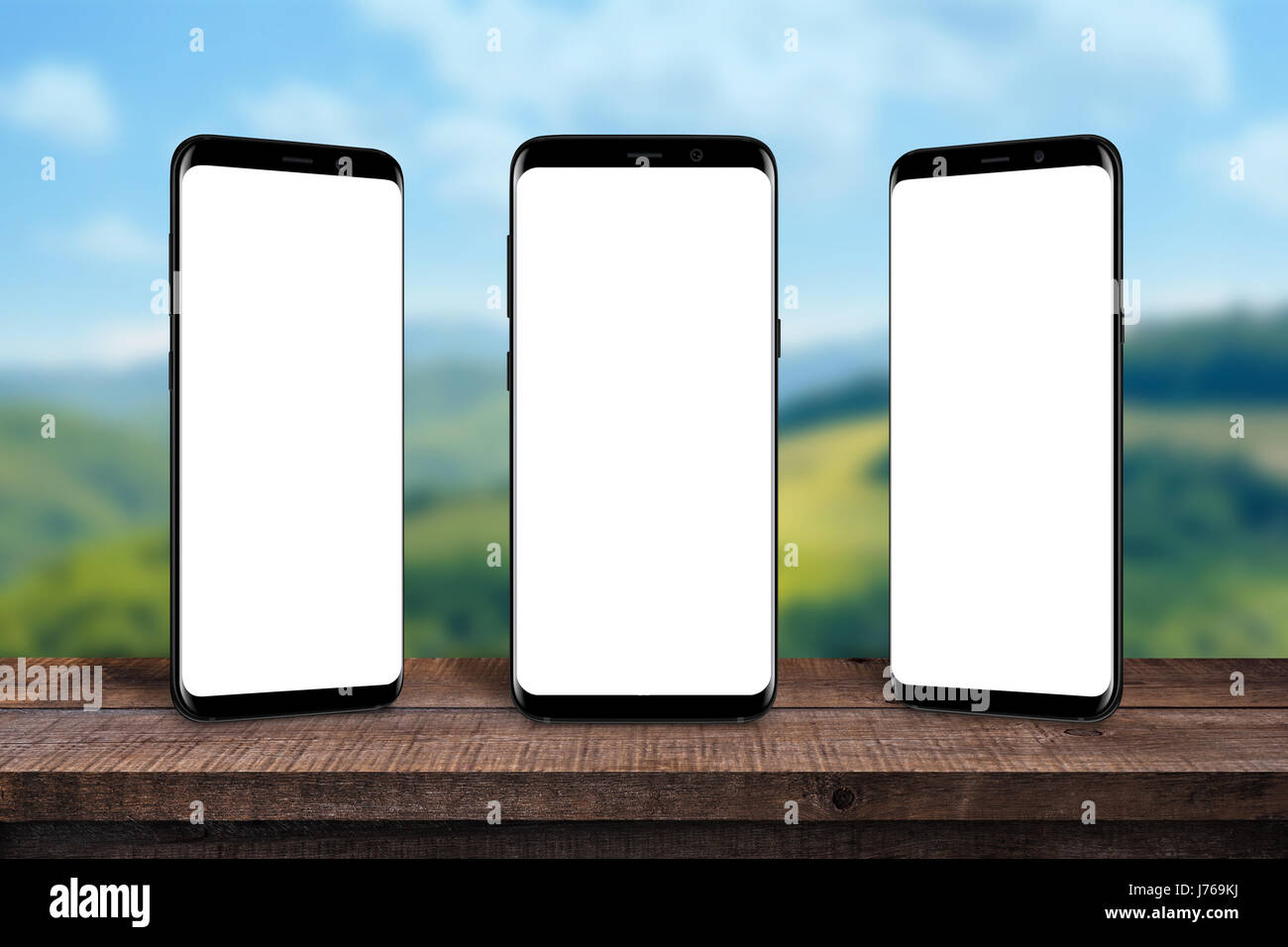 Multiple mobile phones on wooden desk for product, app presentation ...