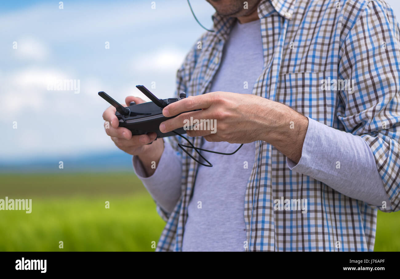 Smart farming concept, farmer using drone remote controller to navigate ...