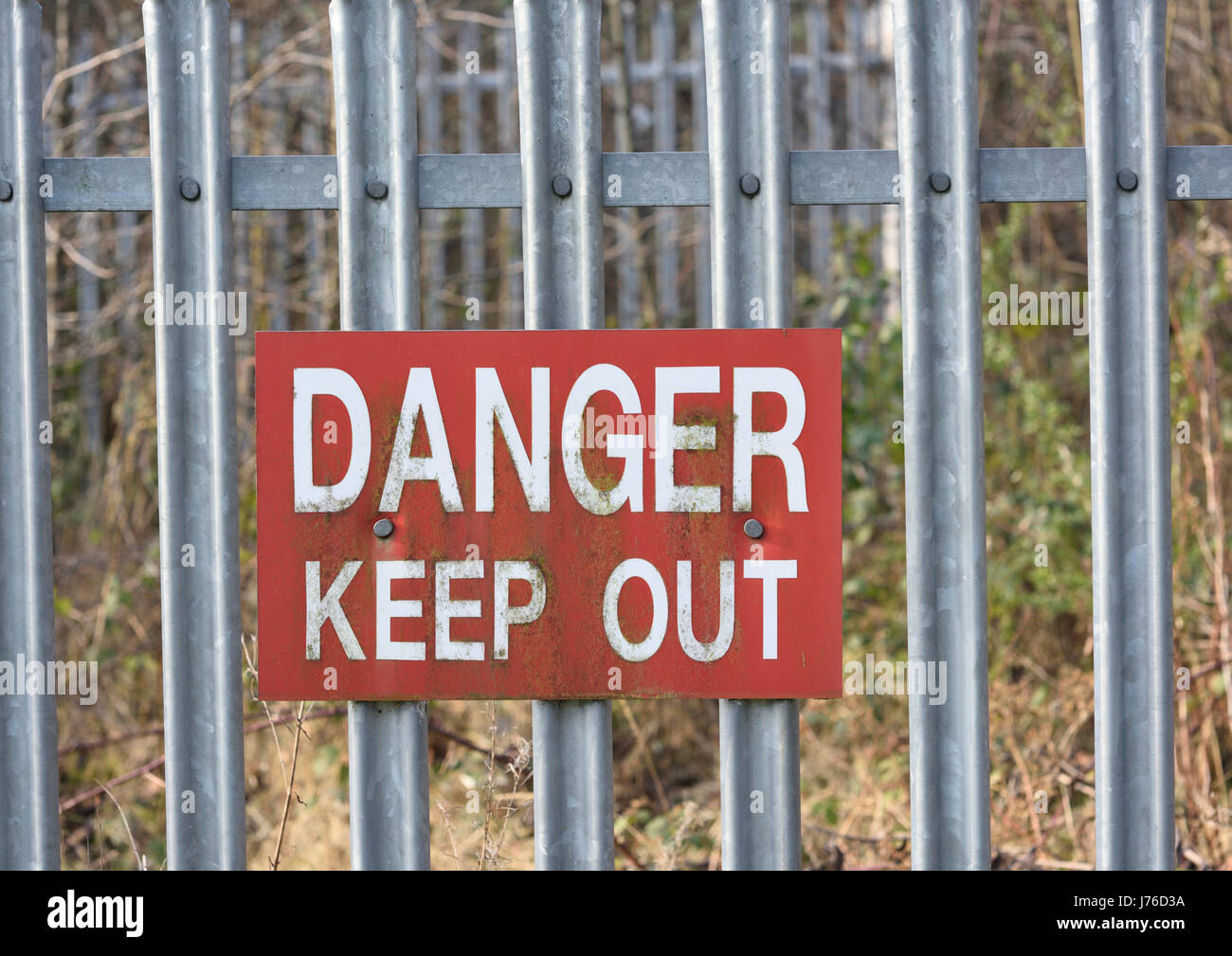 Danger keep out sign, white letters on red background fixed to ...