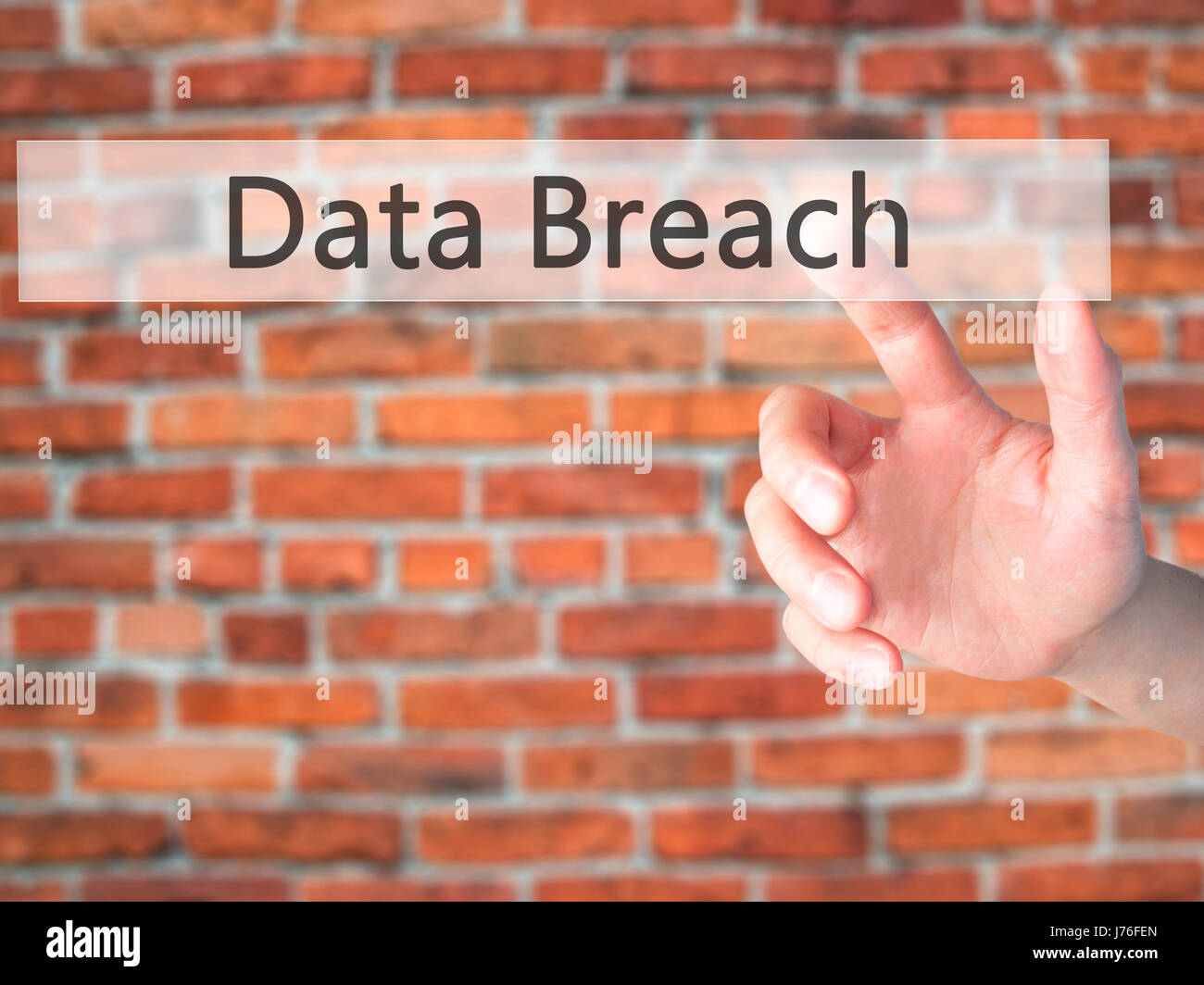 Data Breach - Hand pressing a button on blurred background concept ...