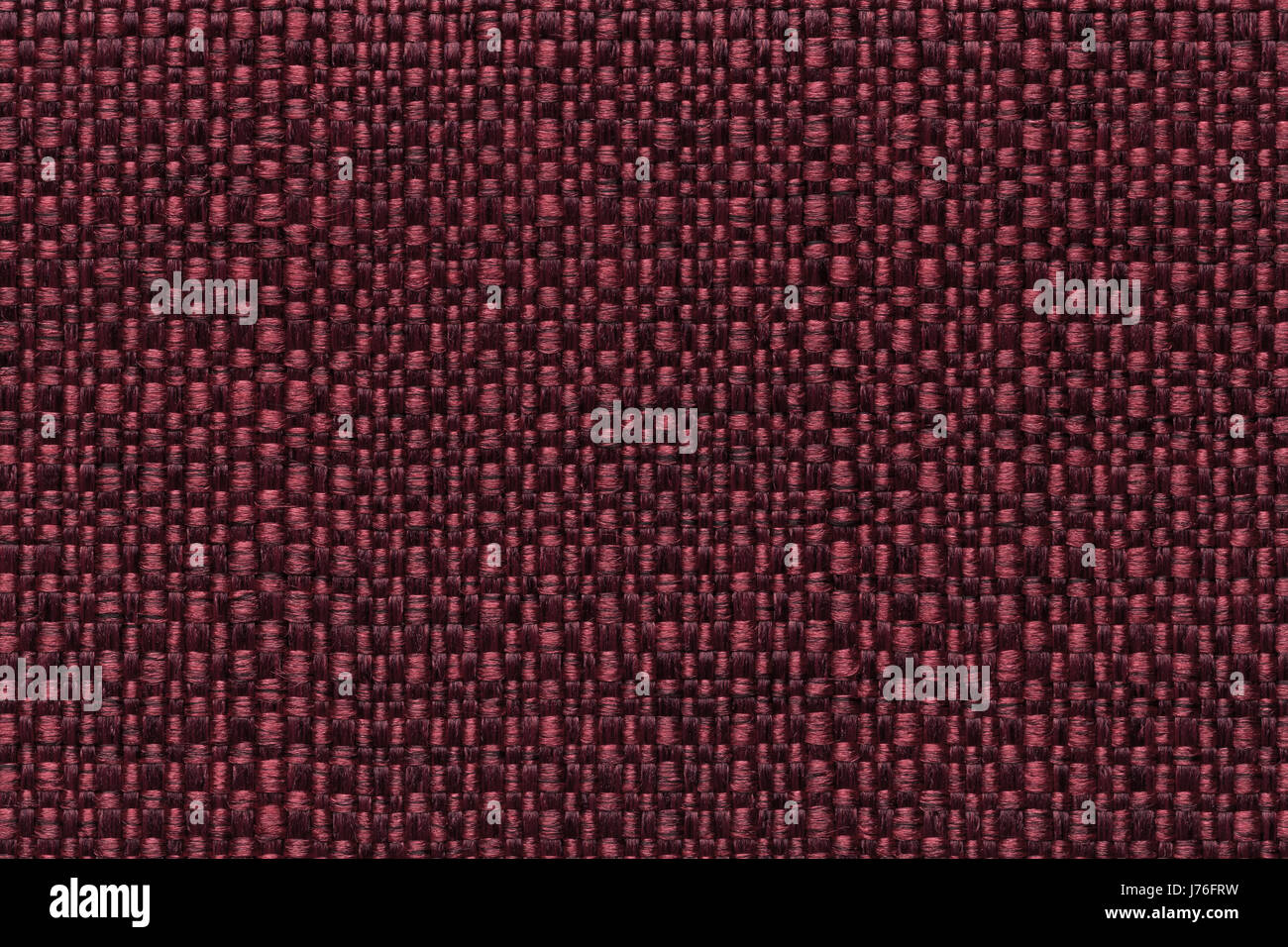 Dark red background with checkered pattern, closeup. Structure of the ...