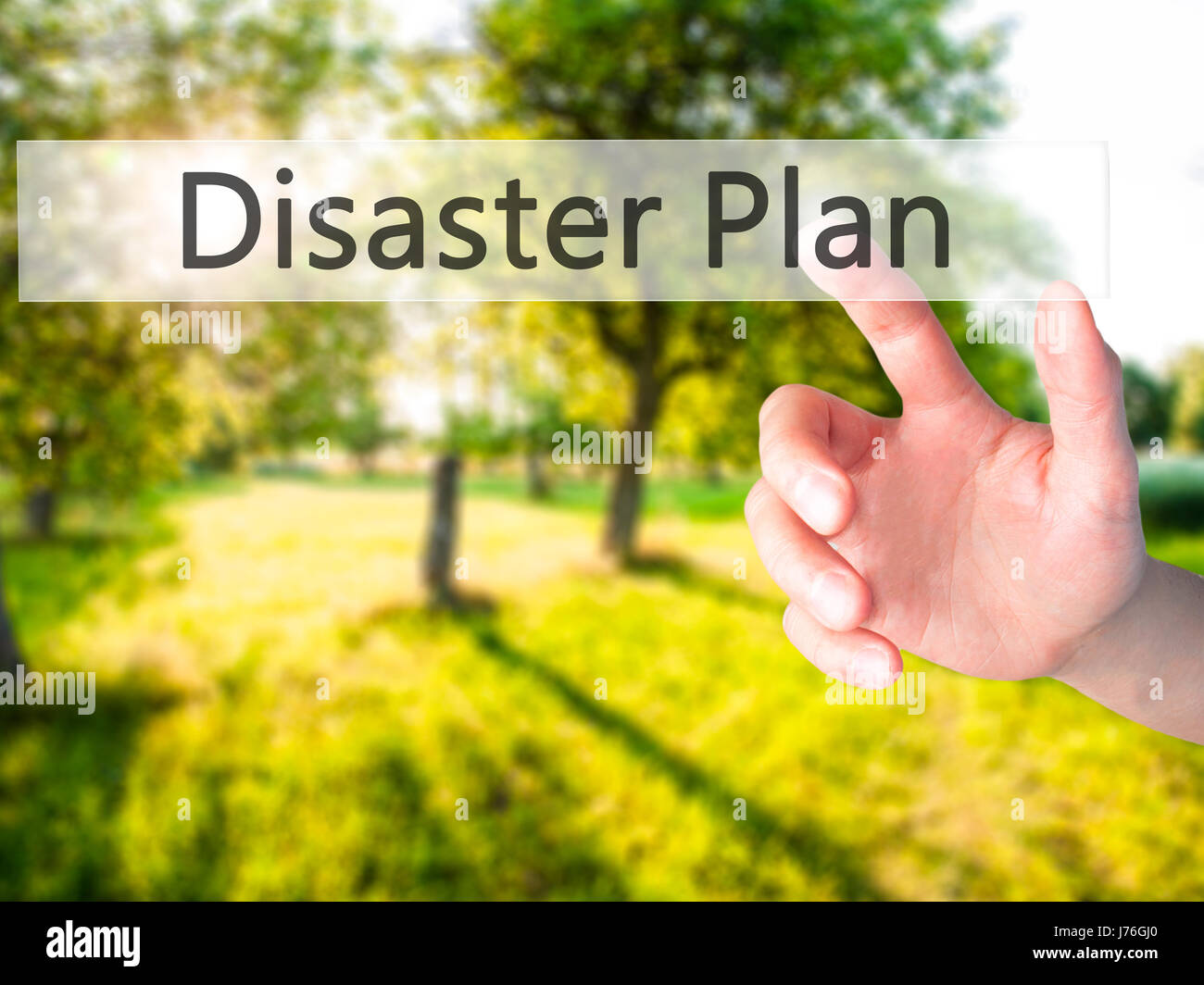 Disaster Plan - Hand pressing a button on blurred background concept ...