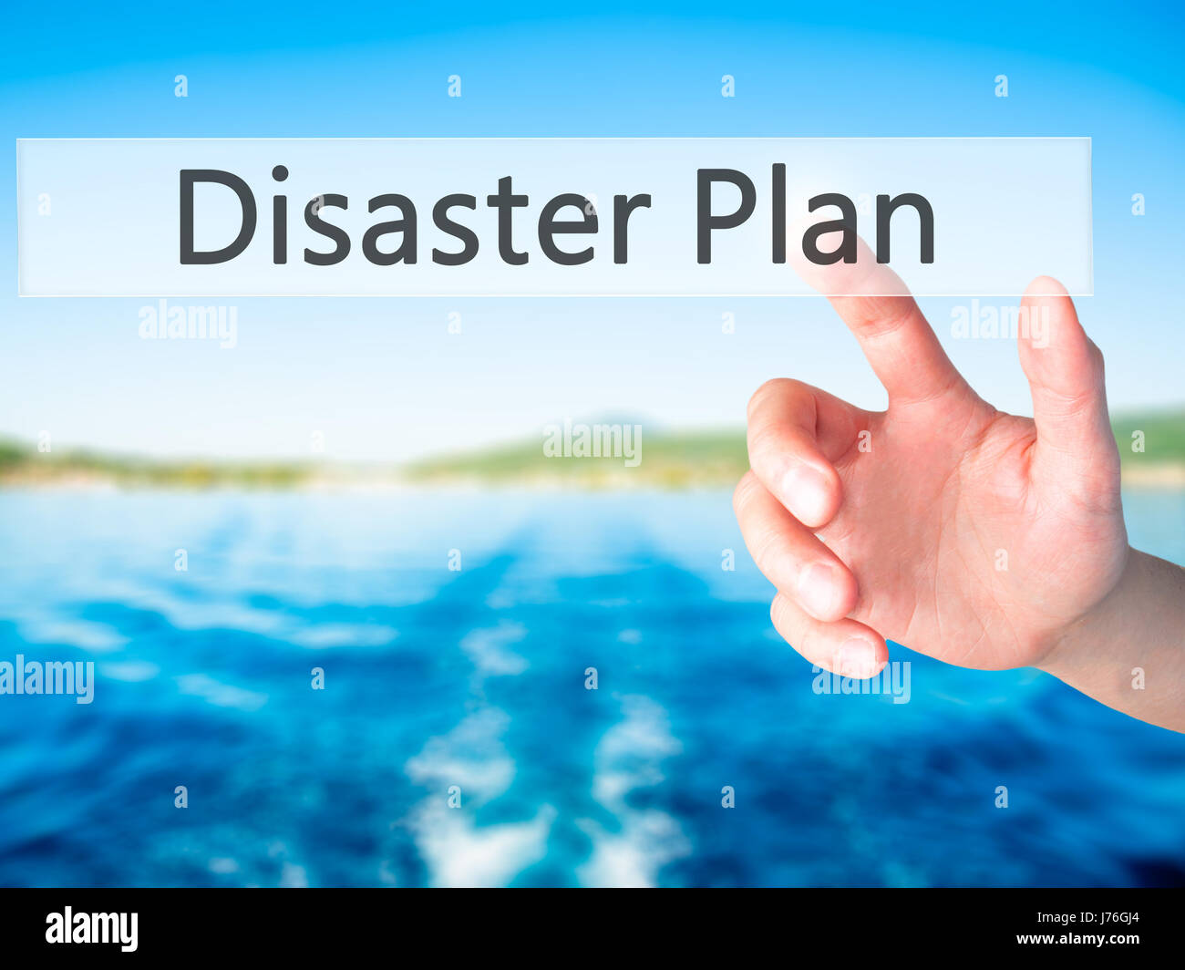Disaster Plan - Hand pressing a button on blurred background concept ...