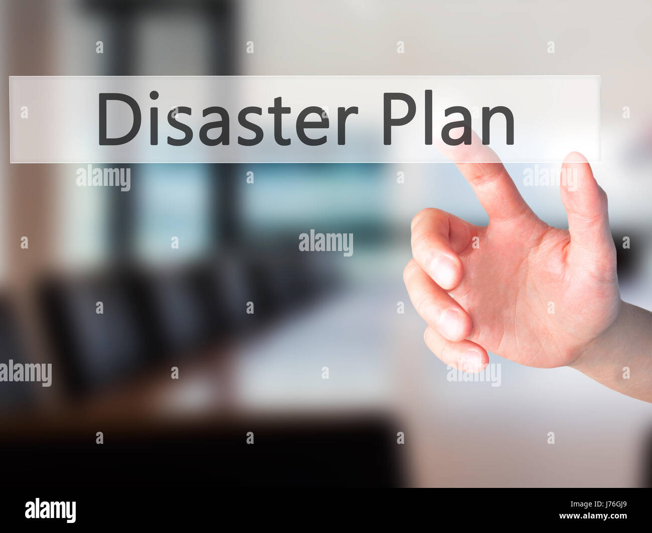 Disaster Plan - Hand pressing a button on blurred background concept ...