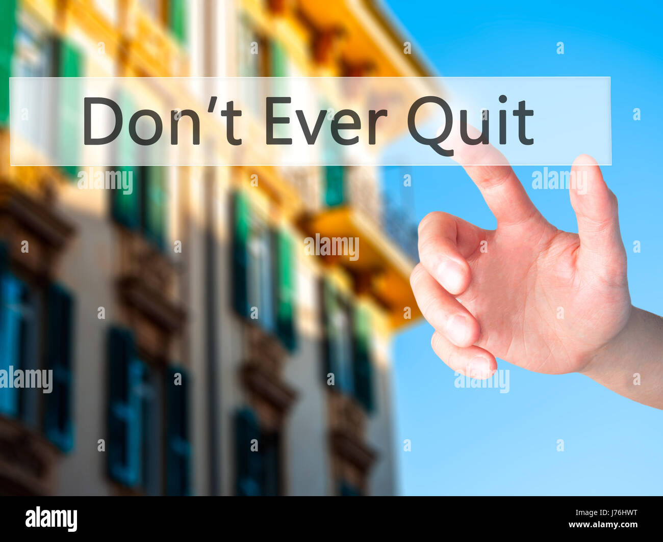 Don't Ever Quit - Hand pressing a button on blurred background concept ...