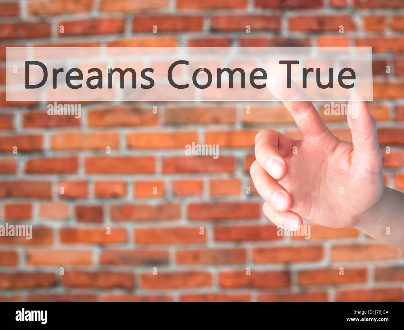 Dreams Come True - Hand pressing a button on blurred background concept ...