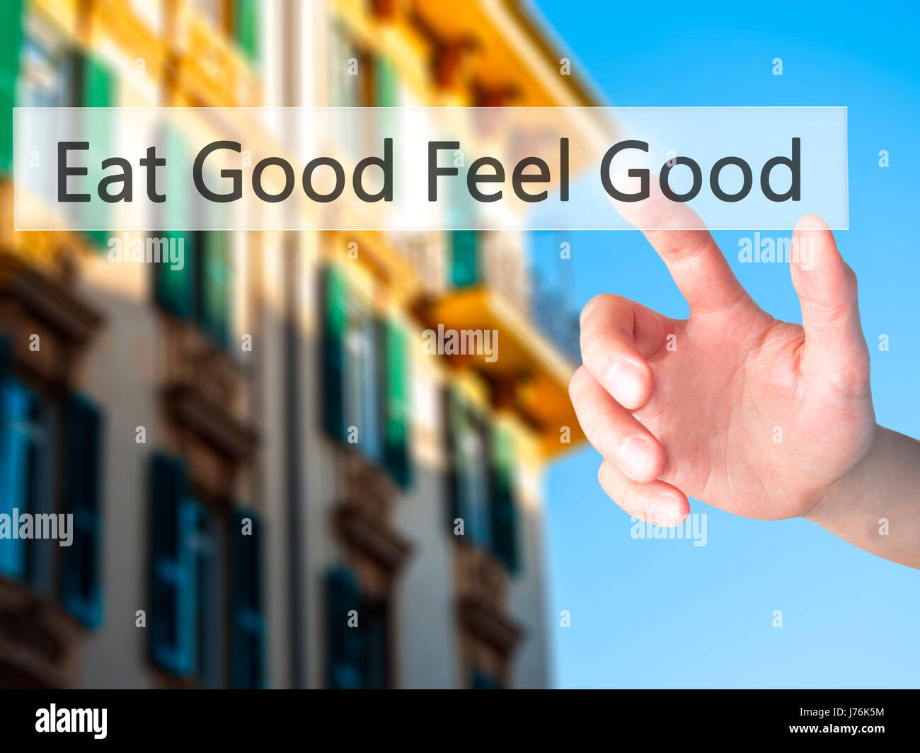 Eat Good Feel Good - Hand pressing a button on blurred background ...