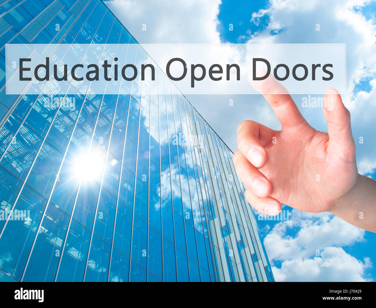 Education Open Doors - Hand pressing a button on blurred background ...